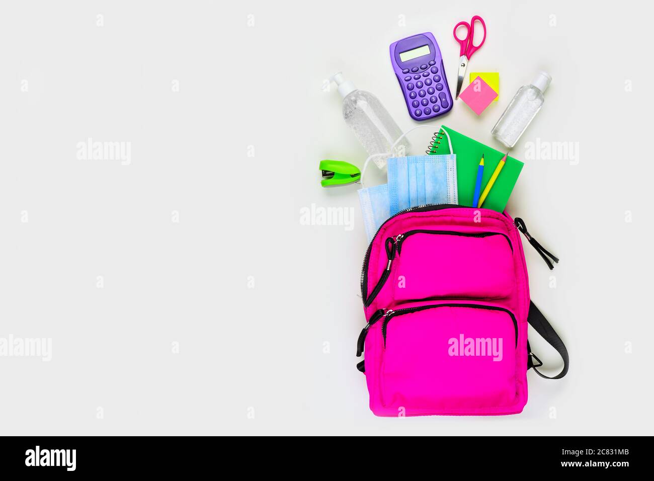 Backpack with school supplies and COVID 19 prevention items. Top view ...