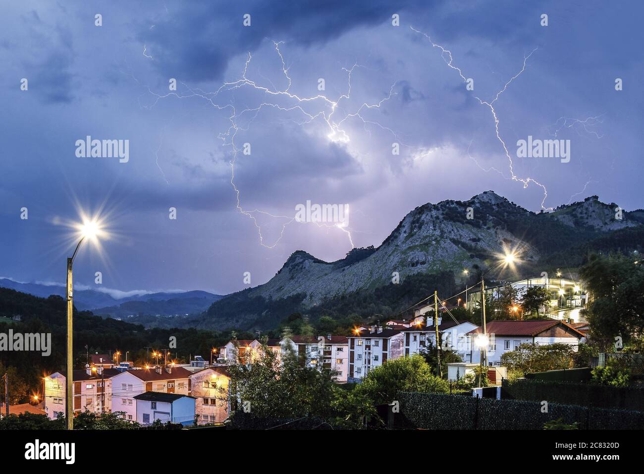 Lightning storm over the city in blue light Stock Photo - Alamy