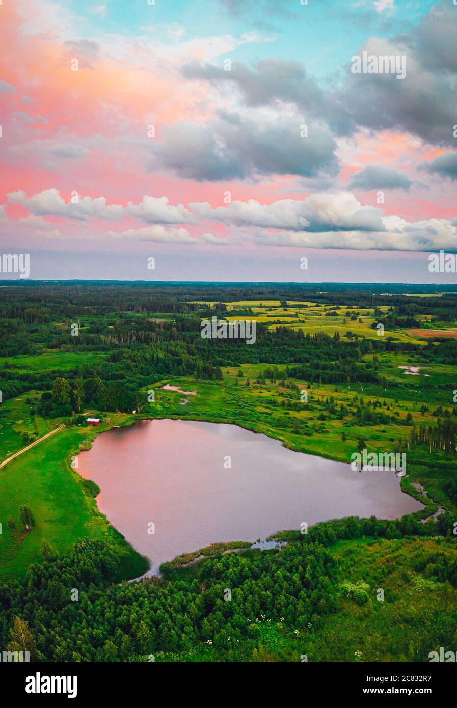 Vertical aerial view of landscape fields in springtime under cloudy sky ...
