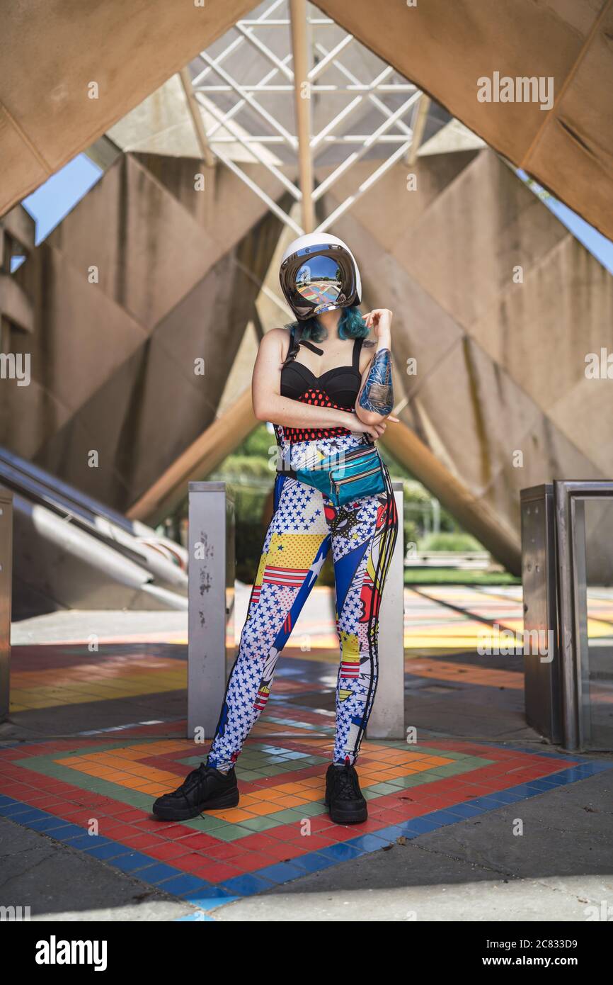 Attractive woman posing and wearing a motorcycle helmet Stock Photo - Alamy