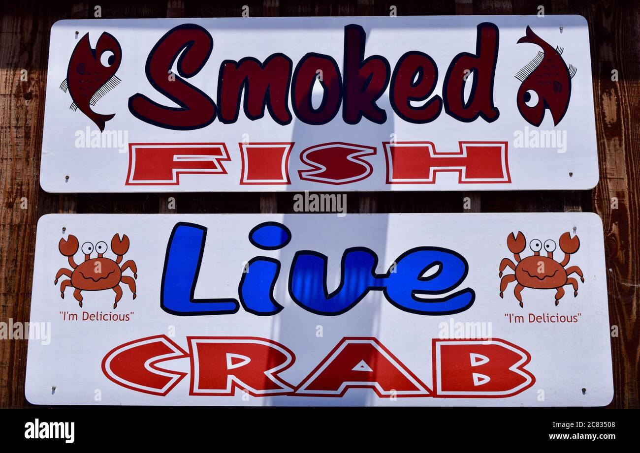 Colorful smoked fish and live crab sign at a seafood market Stock Photo ...