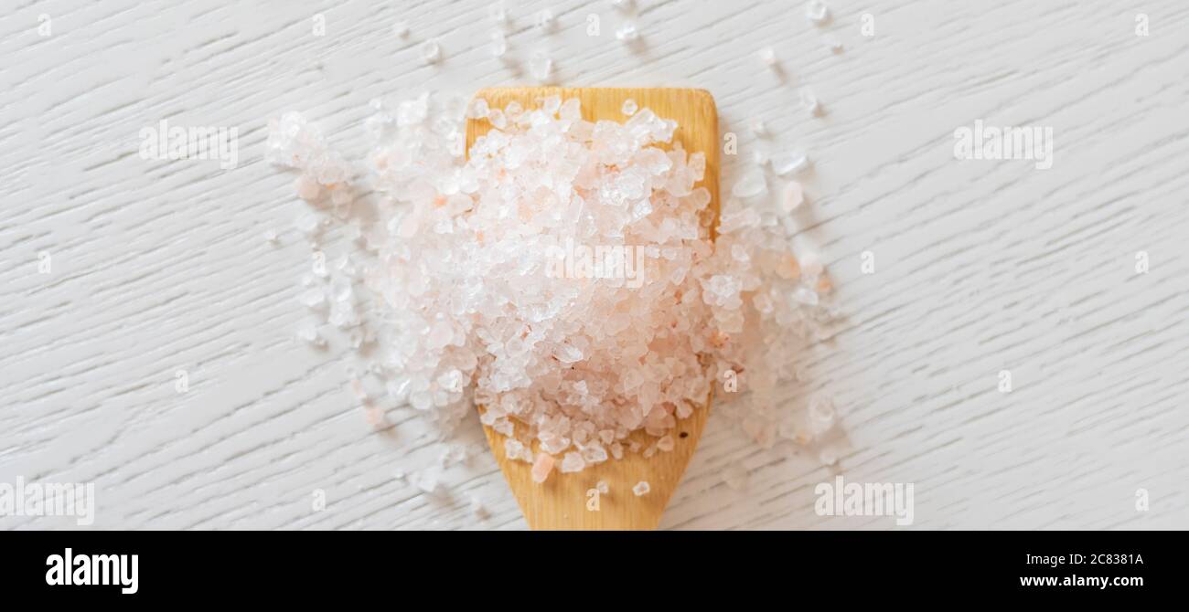 wooden spoon with sea salt on the table, top view isolated Stock Photo ...
