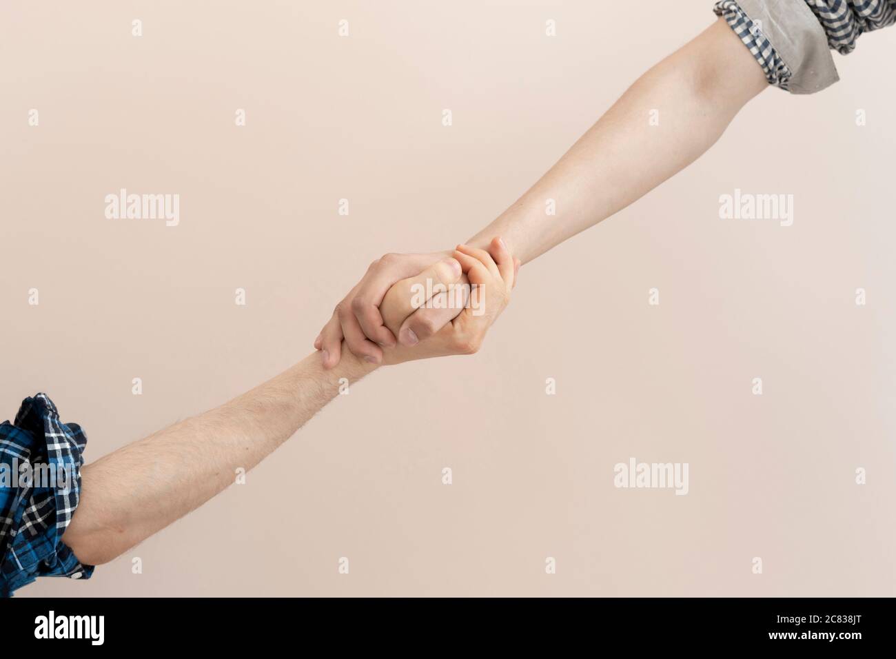 the two hands support each other, handshake, isolated against the ...