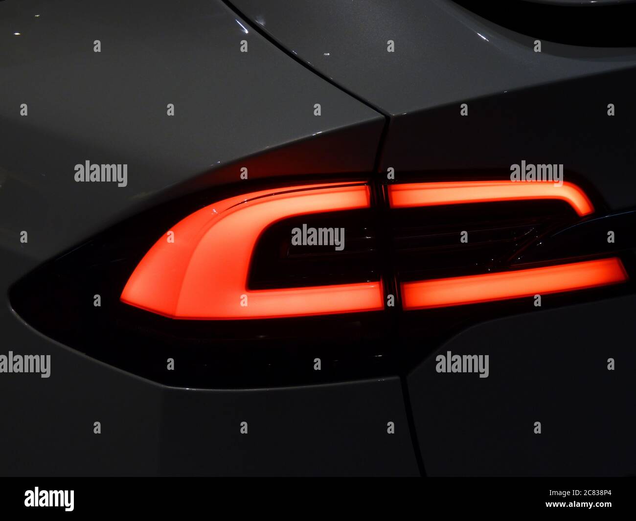 Car's background shining red light in the dark Stock Photo - Alamy