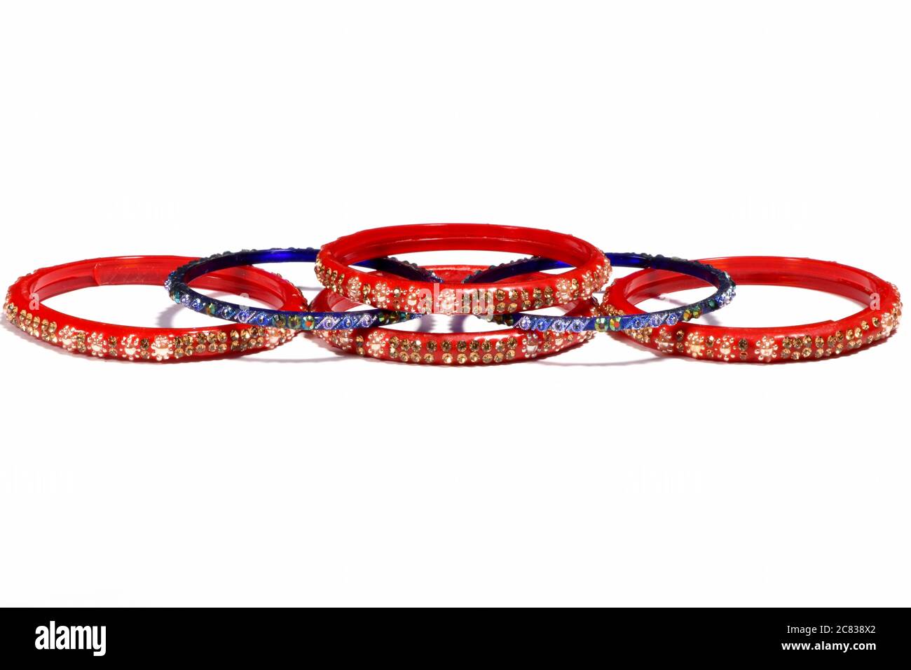 Red and blue bracelets decorated with colorful small stones isolated on ...
