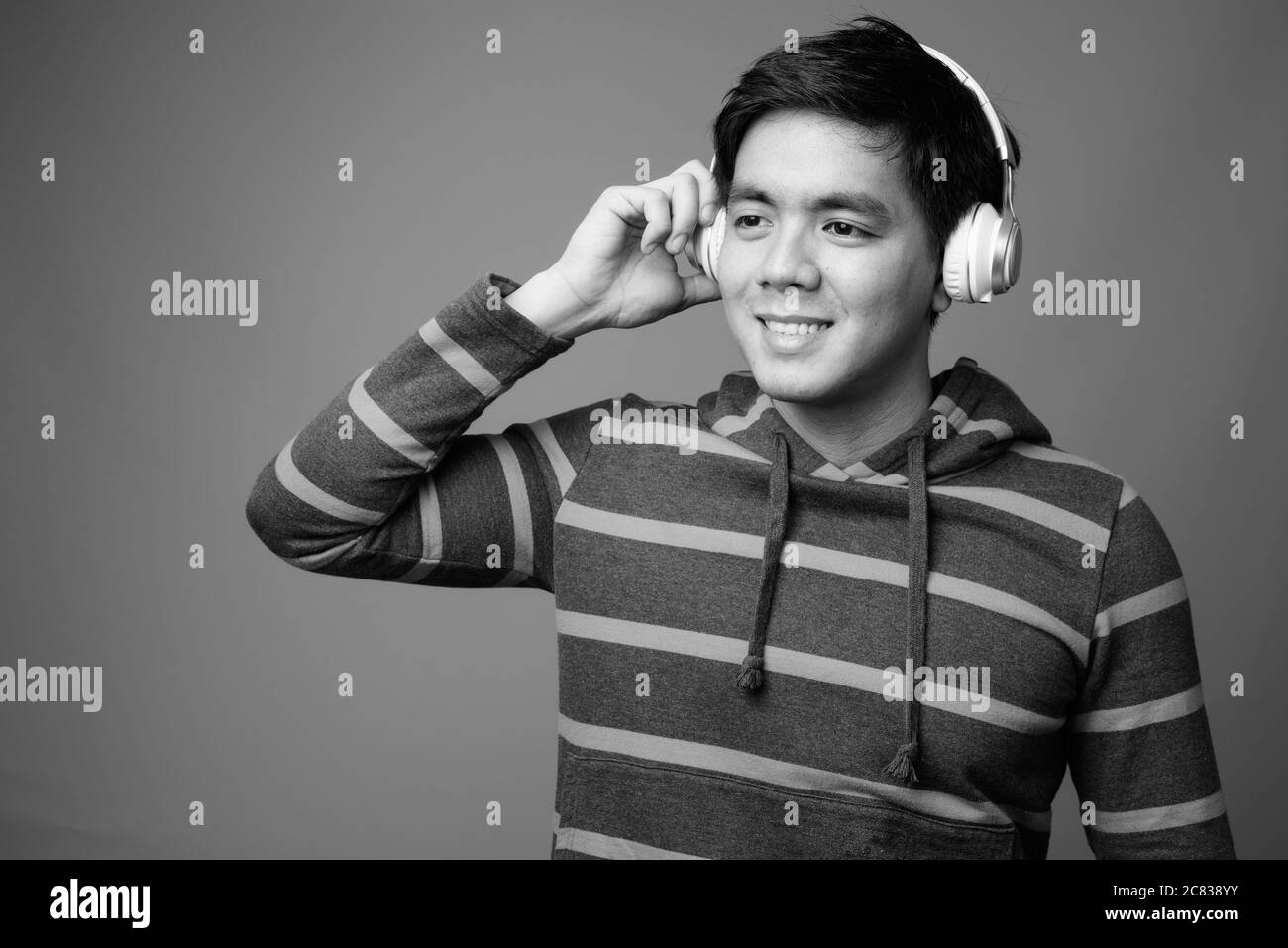 Portrait of young handsome Filipino man wearing hoodie Stock Photo - Alamy