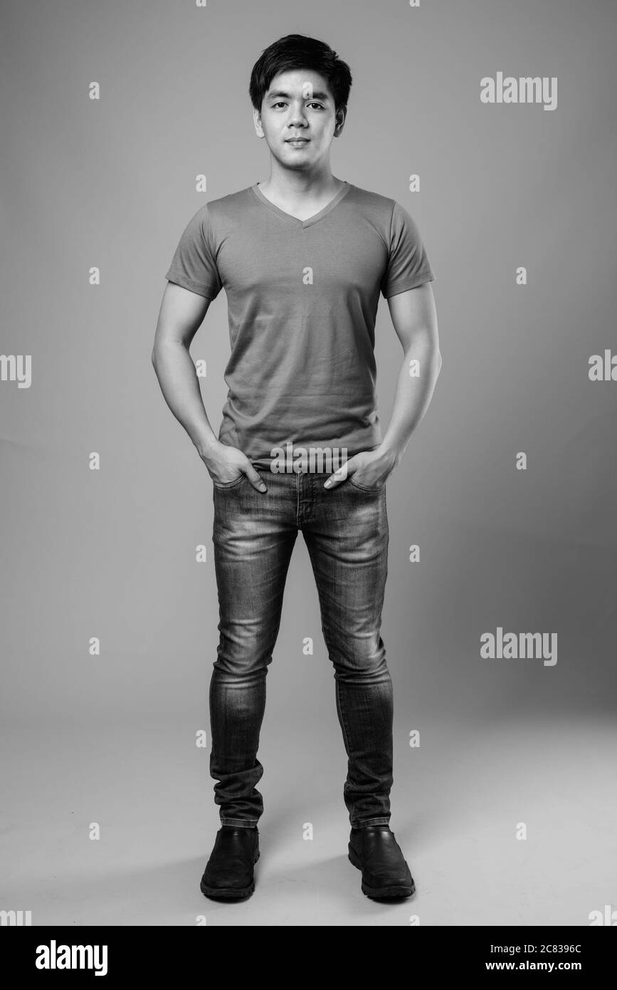 Portrait of young handsome Filipino man against gray background Stock ...