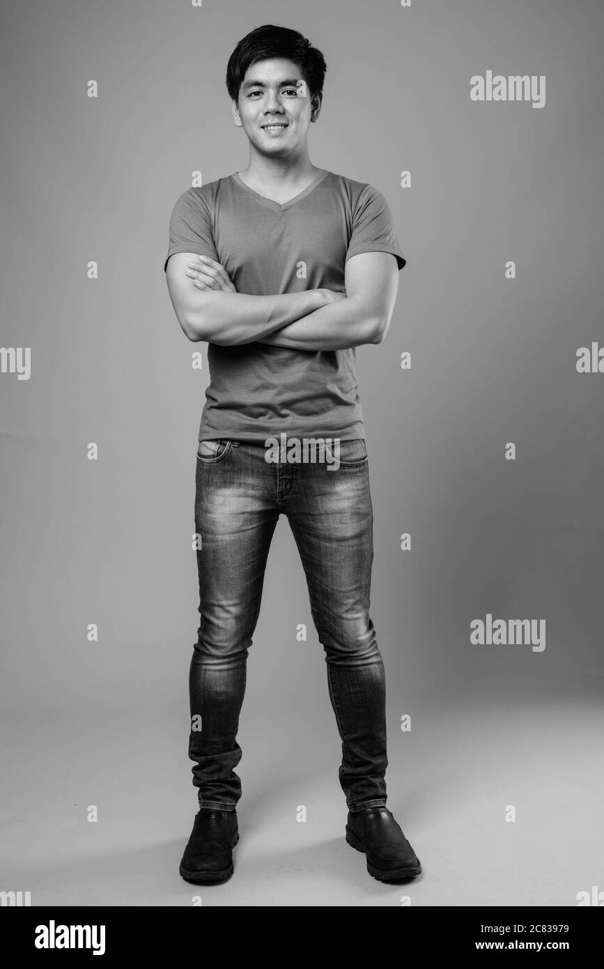 Portrait of young handsome Filipino man against gray background Stock ...