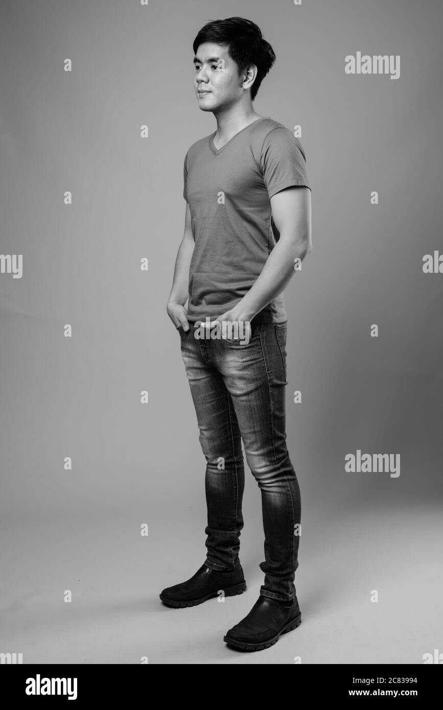 Portrait of young handsome Filipino man against gray background Stock ...