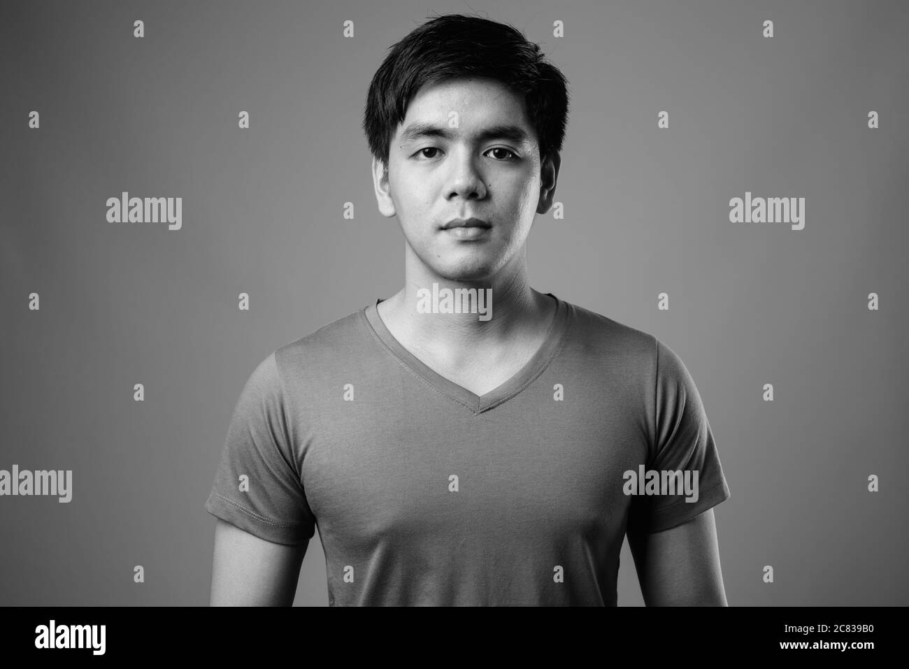 Portrait of young handsome Filipino man against gray background Stock ...
