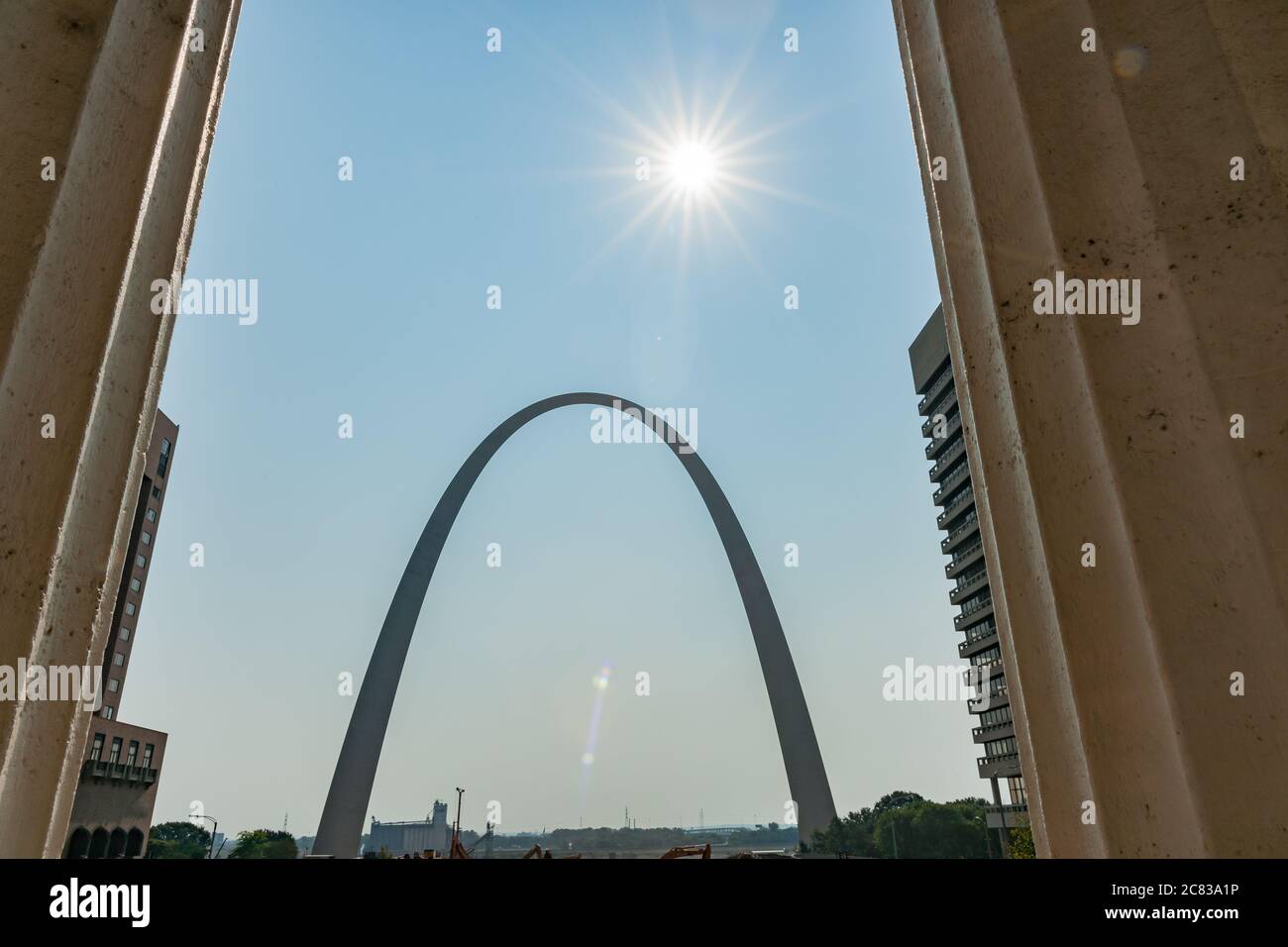 St Louis Gateway Arch at end of city street framed by high-rise ...