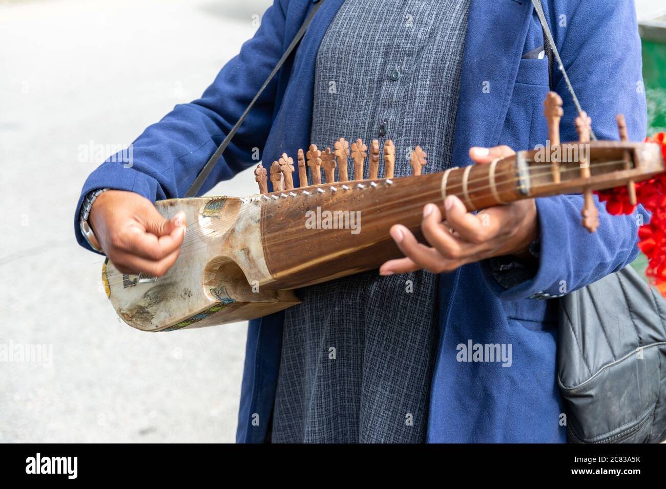 Closeup of a man playing rabab traditional music instrument at a ...