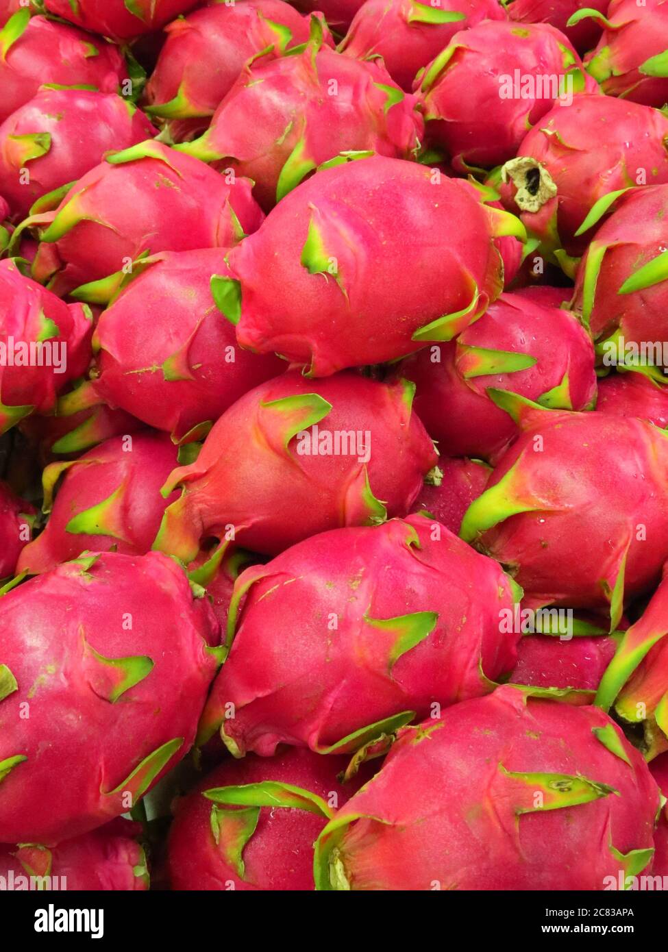 Vertical shot of fresh Pitaya fruits in a bunch in the market Stock ...