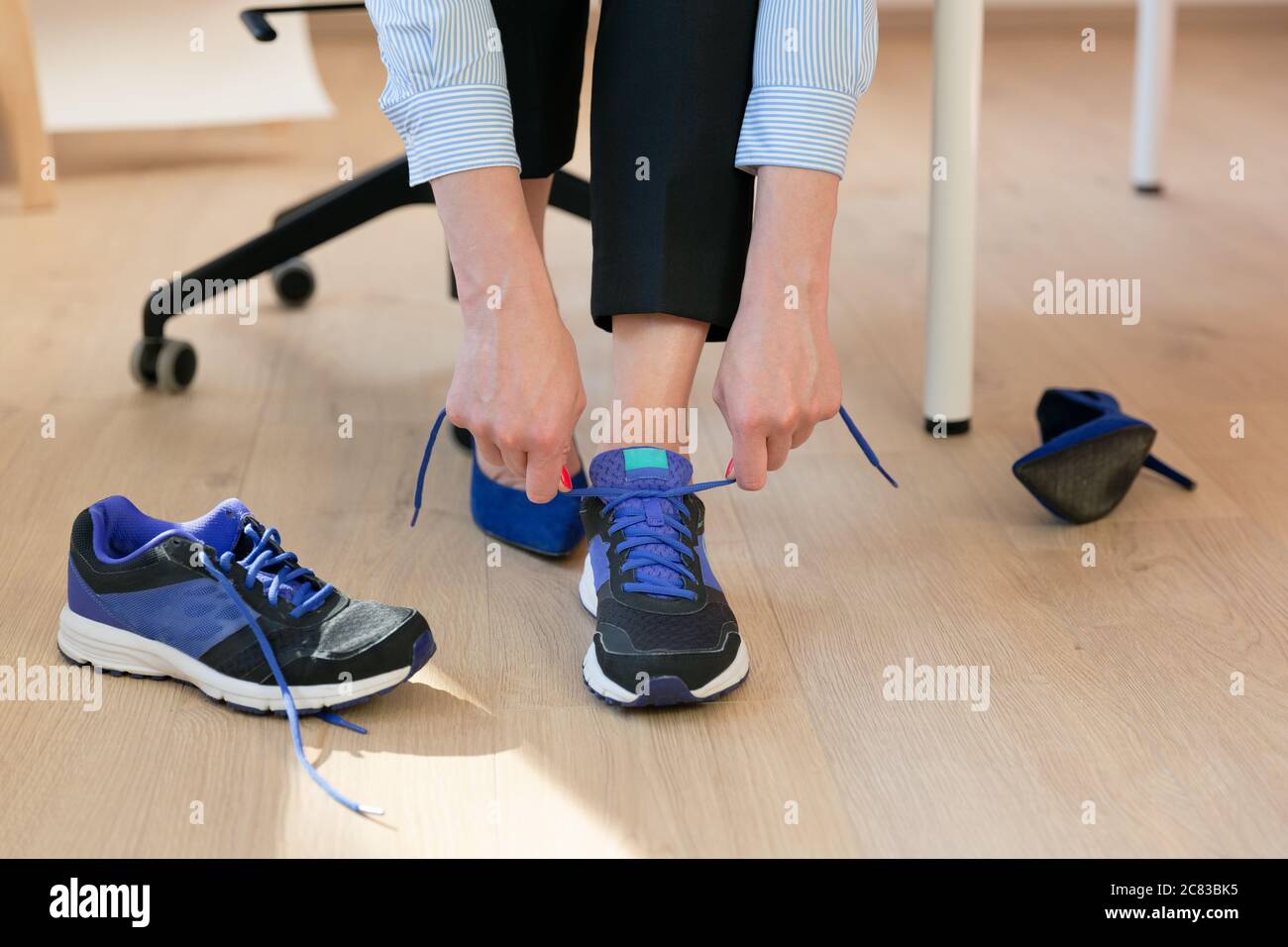 Woman changing high heels, office shoes after working day while sitting ...