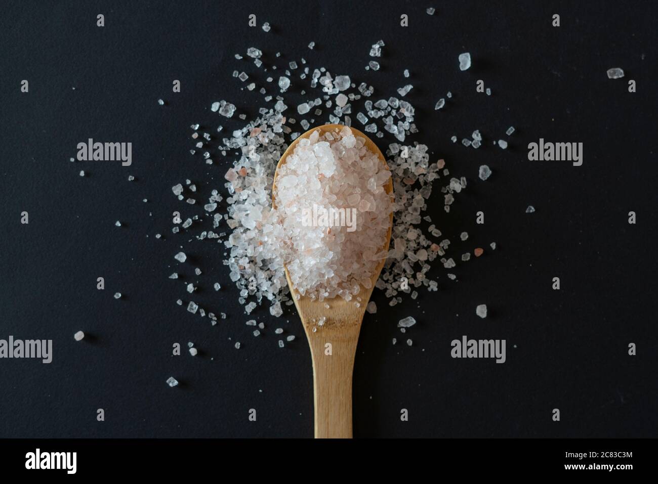 wooden spoon with sea salt on the table, top view isolated Stock Photo ...