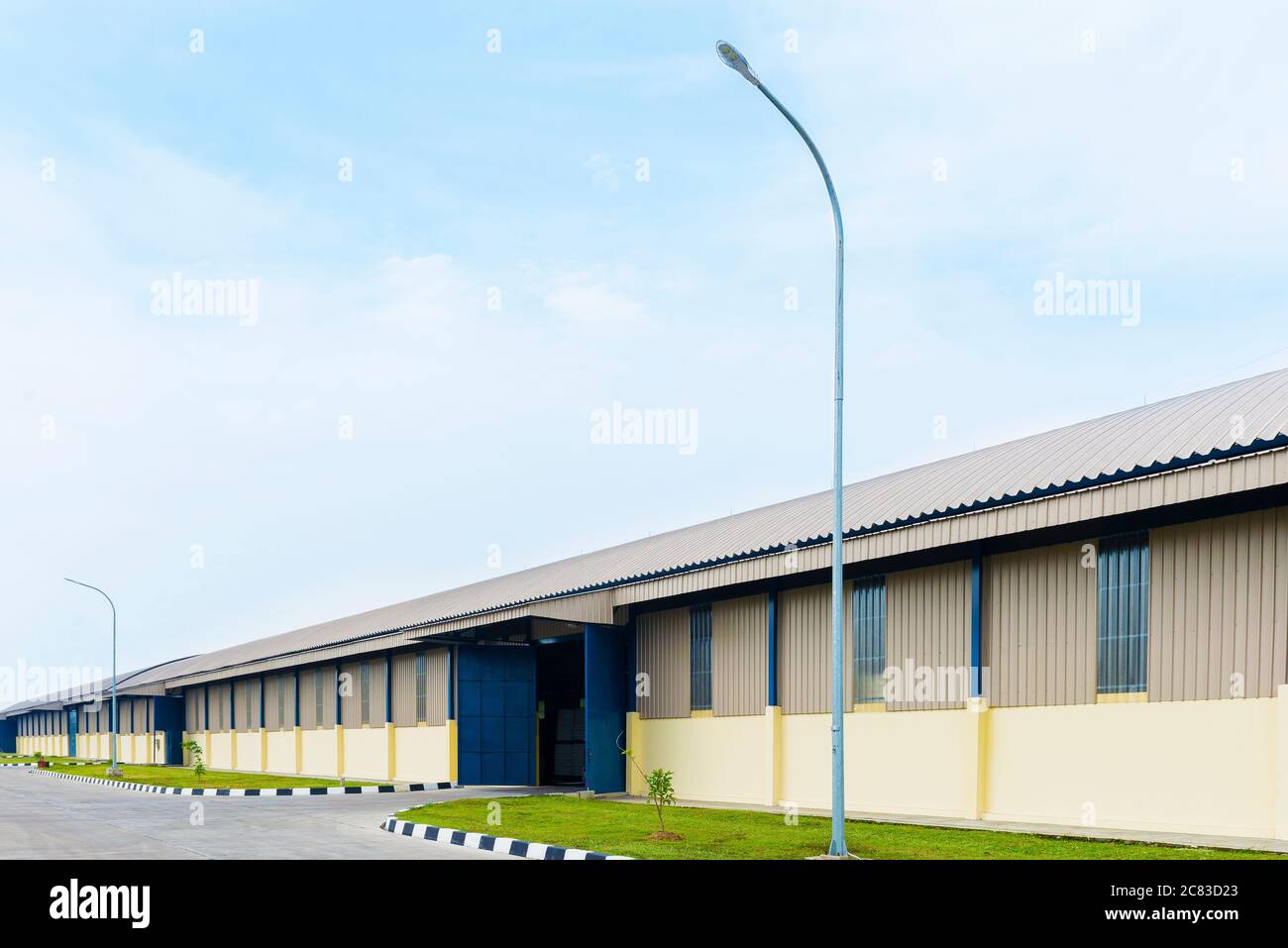 Exterior view of a warehouse building with a blue sky background Stock ...