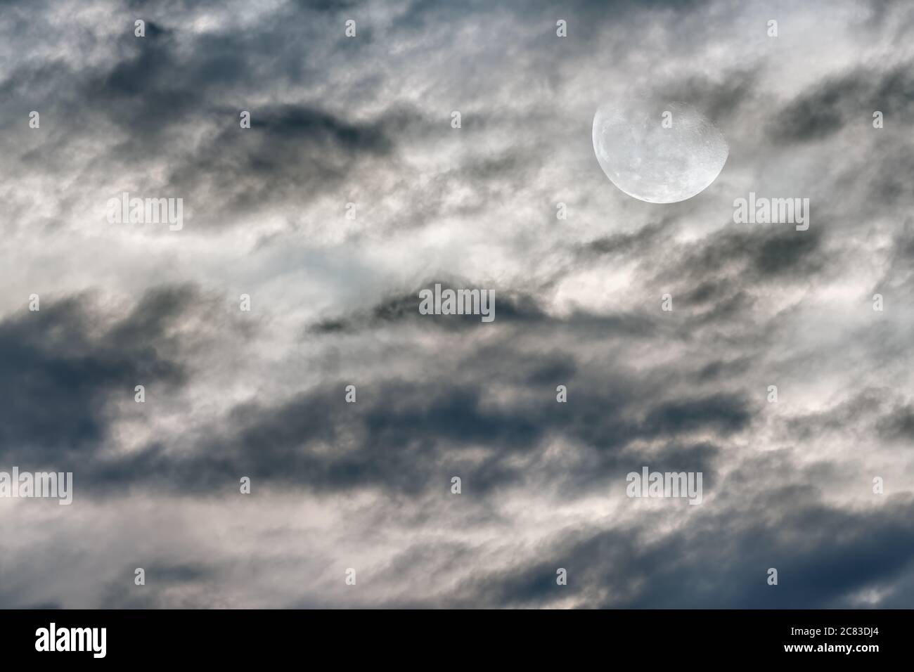 A Dark Moody Overcast Sky With a Full Moon Rising Stock Photo - Alamy