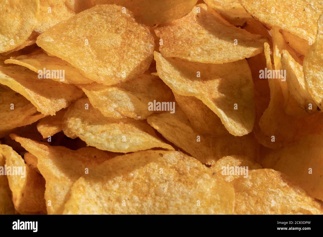 a macro view of the yellow potato chips background pattern Stock Photo ...