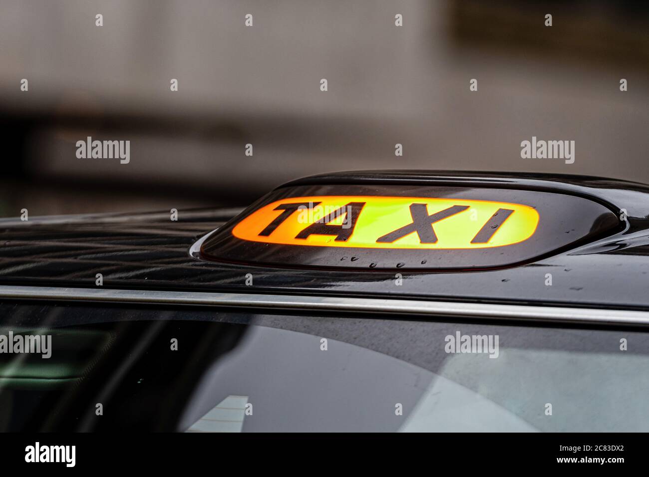 A british london black taxi cab sign with defocused background - image ...