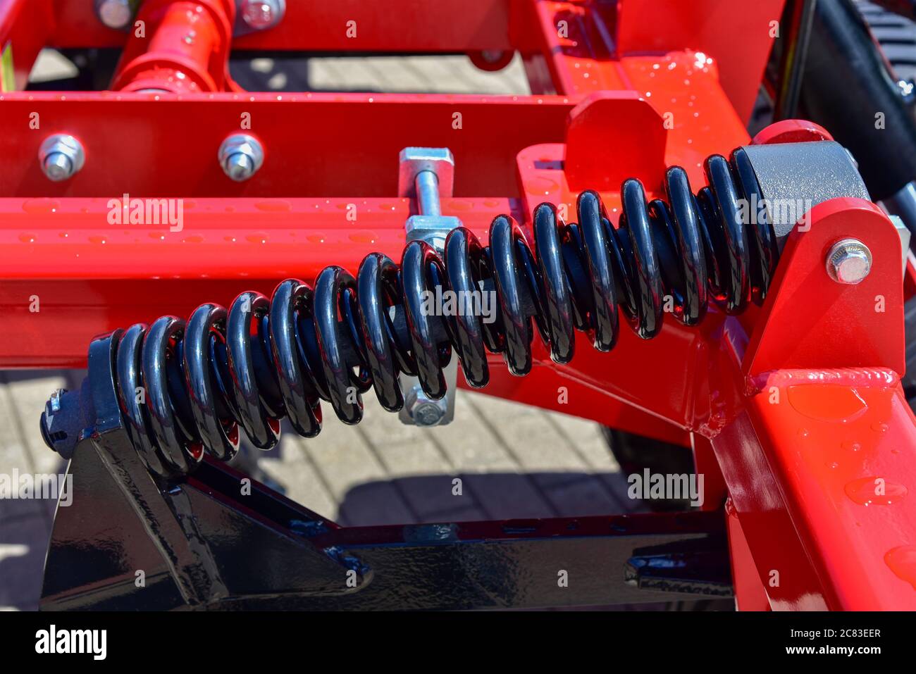 Large red shock absorber on an industrial vehicle Stock Photo - Alamy