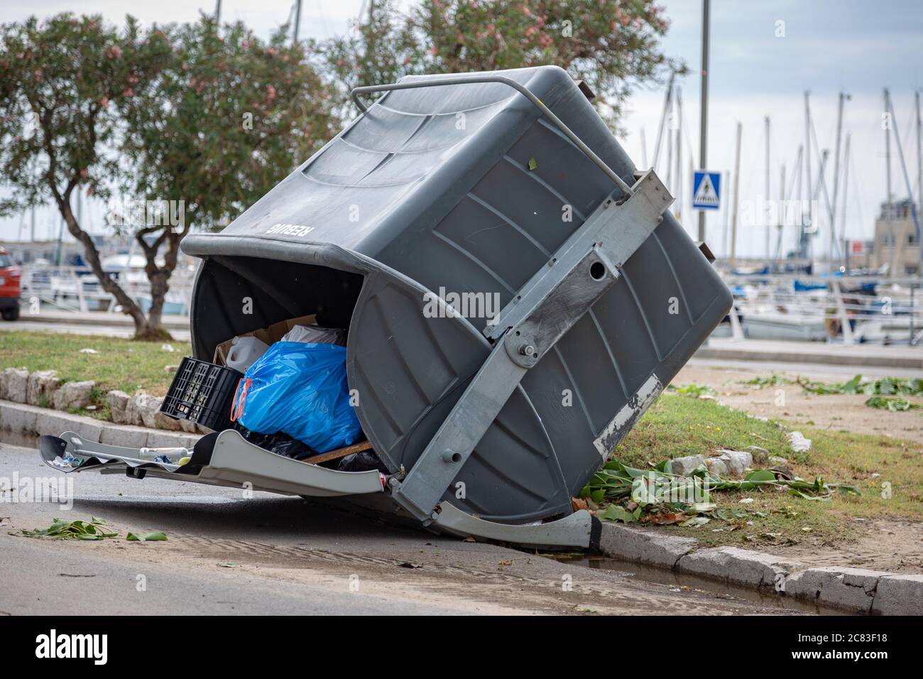 Grey upside-down waste bean in the street Stock Photo - Alamy