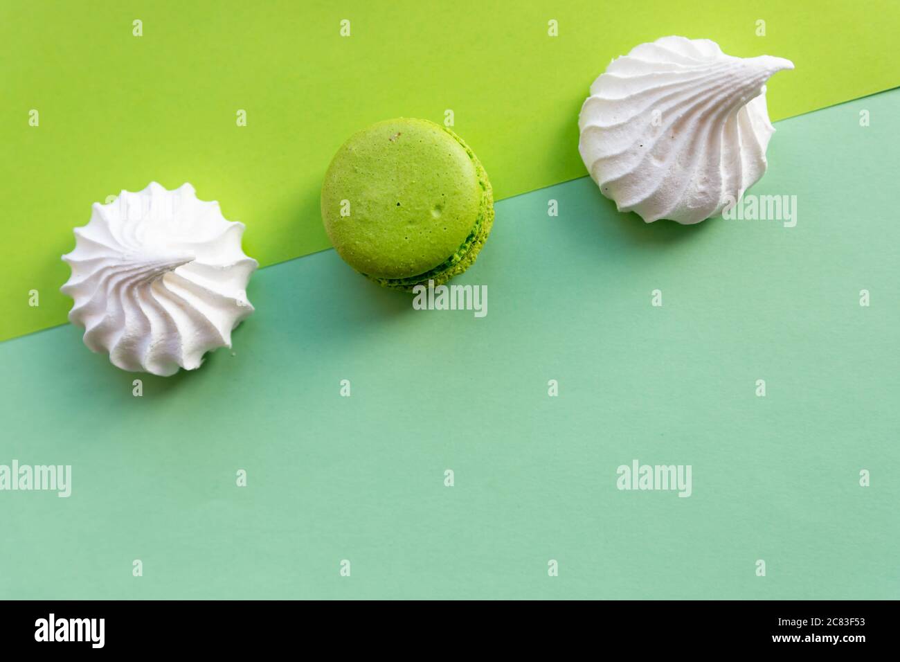 Colorful cake macaron or macaroon,white meringues on green, turquoise ...