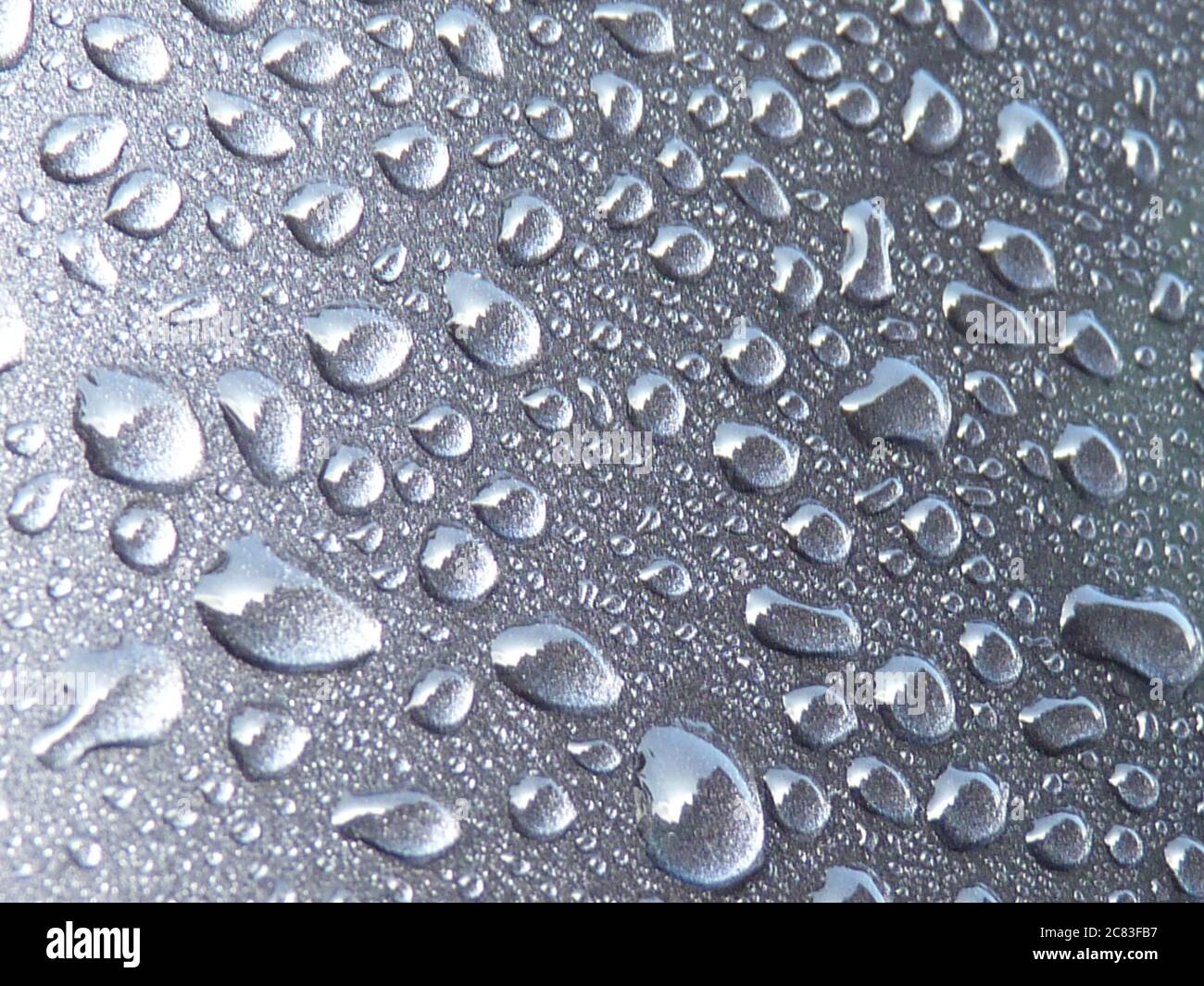 Closeup shot of waterdrops on a gray surface Stock Photo - Alamy