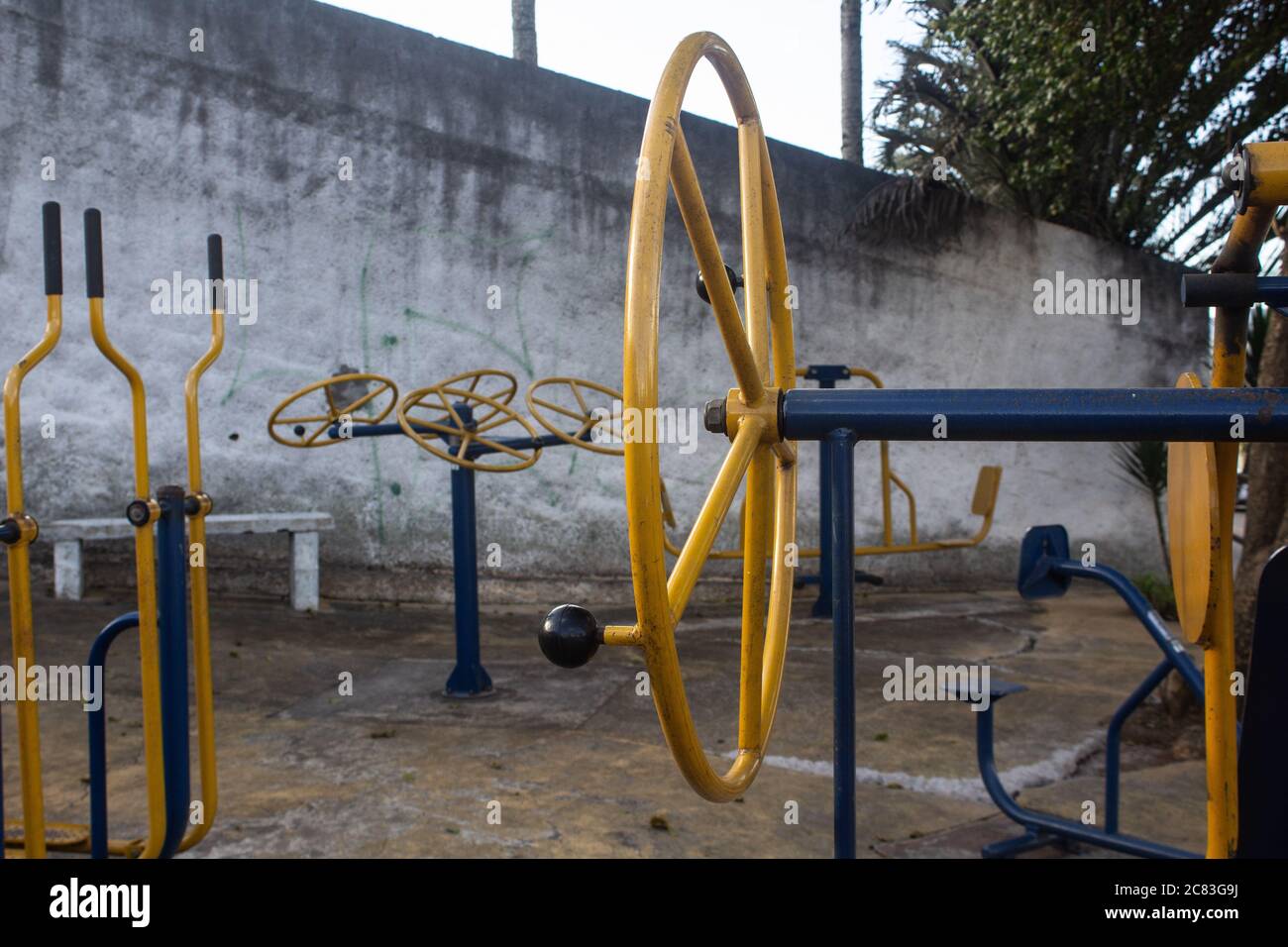 Outdoor exercise space with yellow metal equipment at a park Stock ...