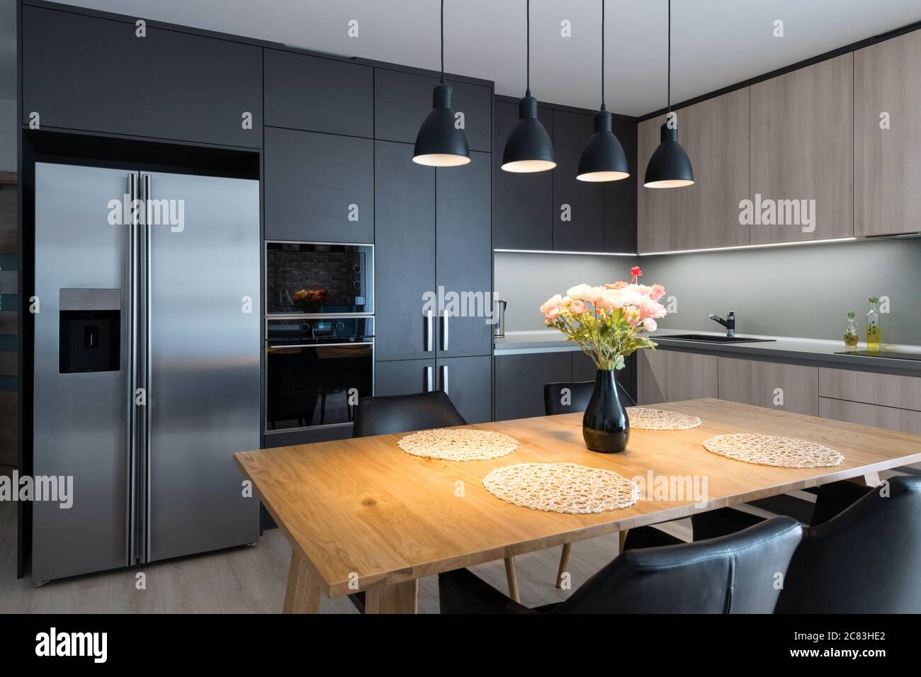 Dining table in kitchen of modern house Stock Photo - Alamy