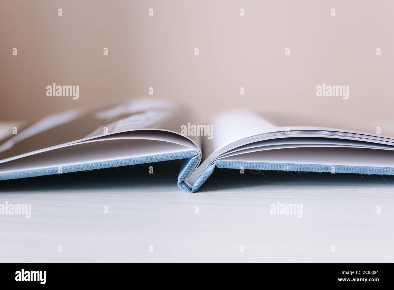 Buttom view of open photobook on white wooden table Stock Photo - Alamy