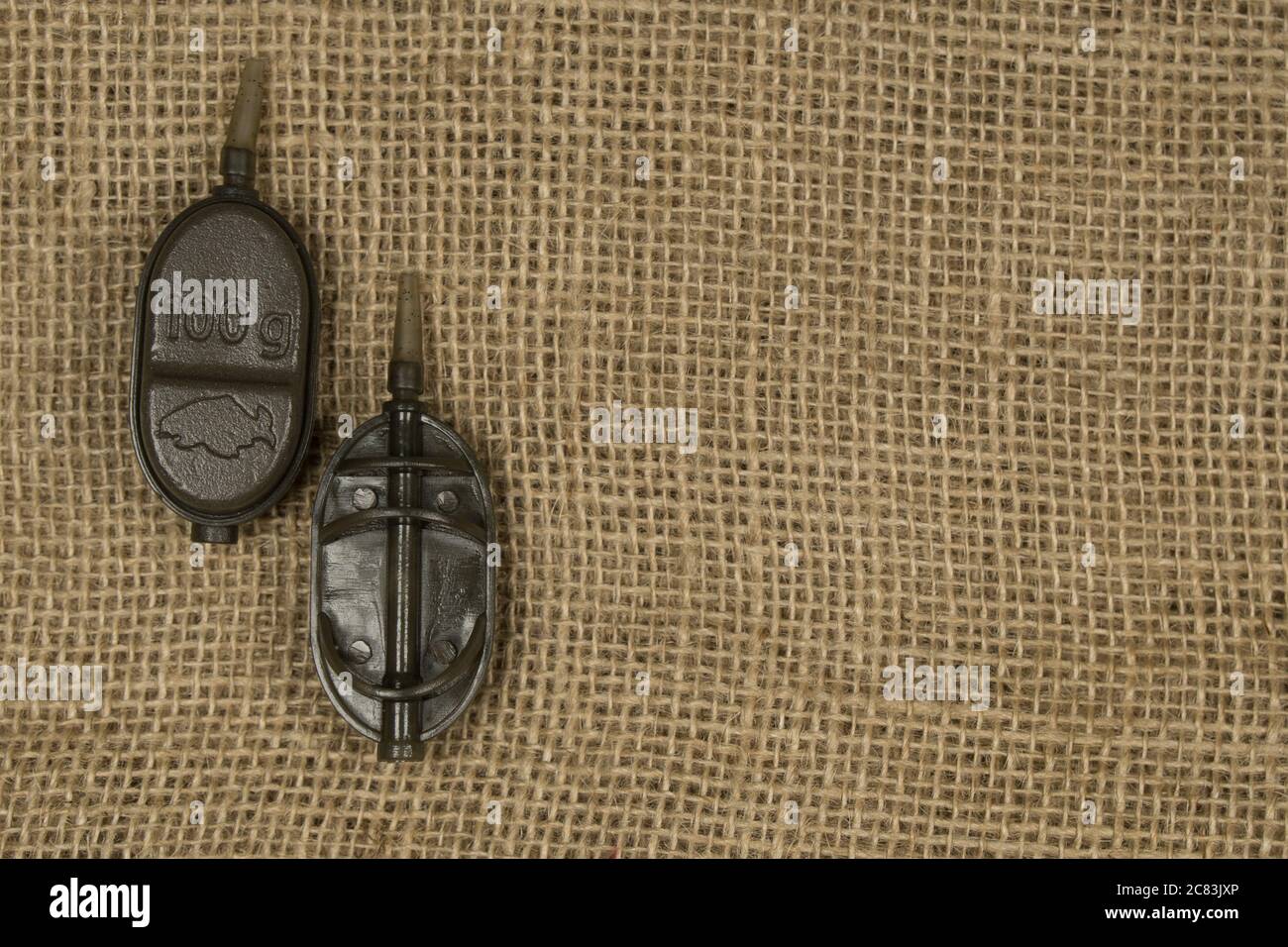 Fishing troughs and fish bait on burlap background. Set of fish feeders ...