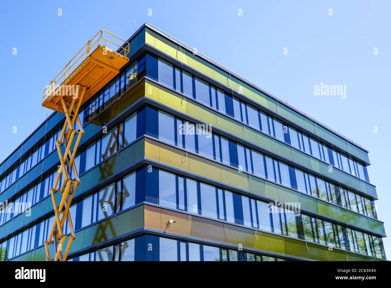 modern building facade repair using a high scissor lift with a platform ...