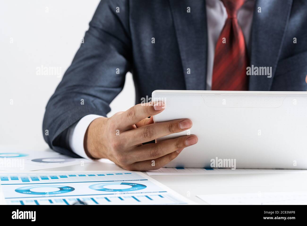 Businessman using tablet computer at office desk Stock Photo - Alamy