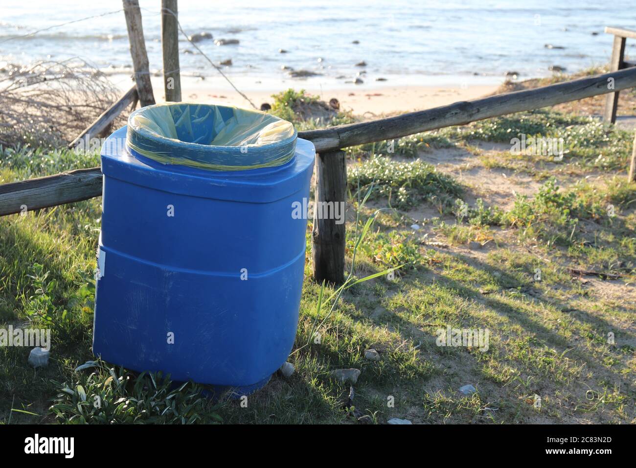 Blue garbage bin at a beach Stock Photo - Alamy