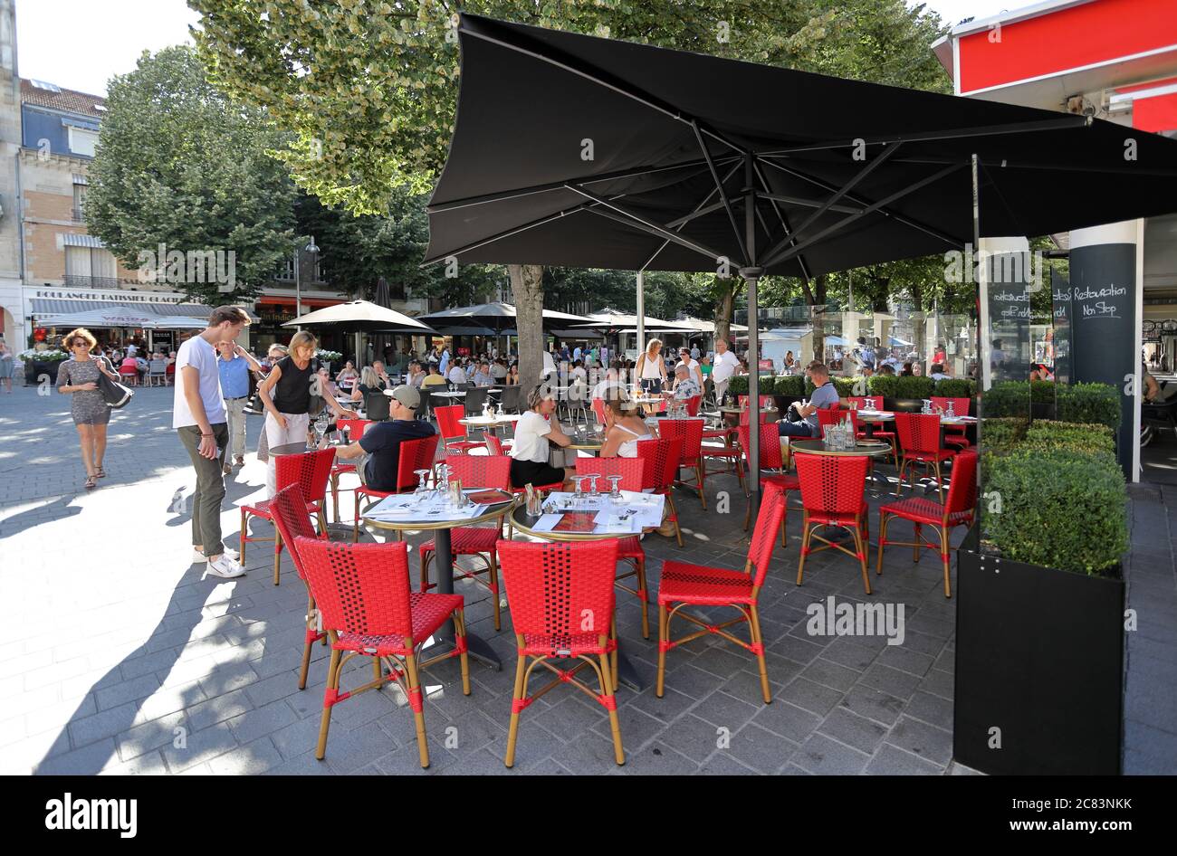 Reims, France 06/29/2019 View of the street with people sitting outside ...