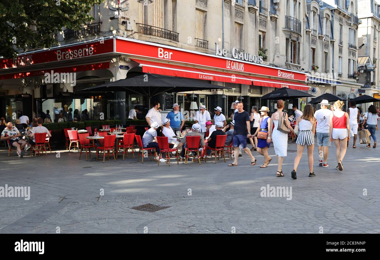 Reims, France 06/29/2019 View of the street with people sitting outside ...