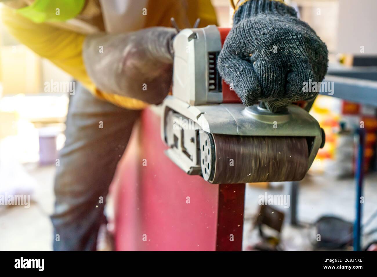 Carpenter is shaving red wood door by his shaving machine in outdoor ...