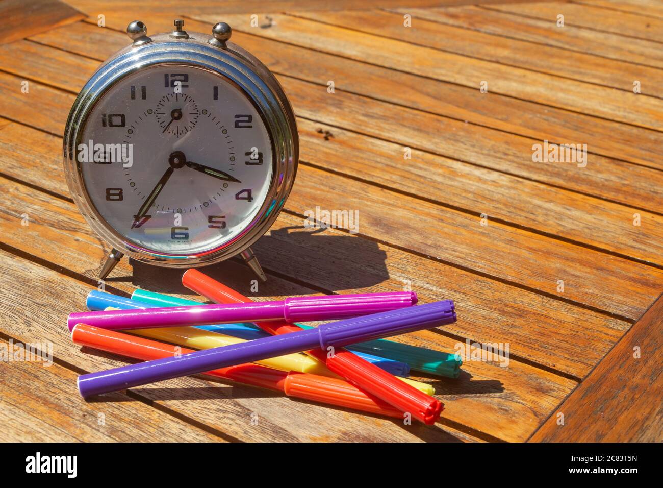 Alarm clock and felt-tip pencils to symbolize time to go back to school ...