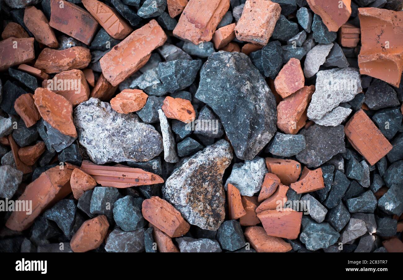 Background with different size and colour rocks and bricks on the ...