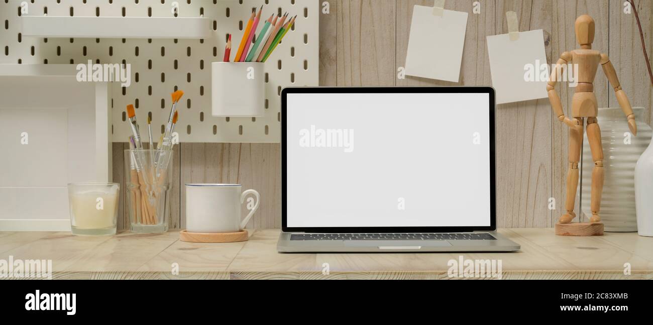 Close up view of study tale with mock up laptop, cup, stationery ...