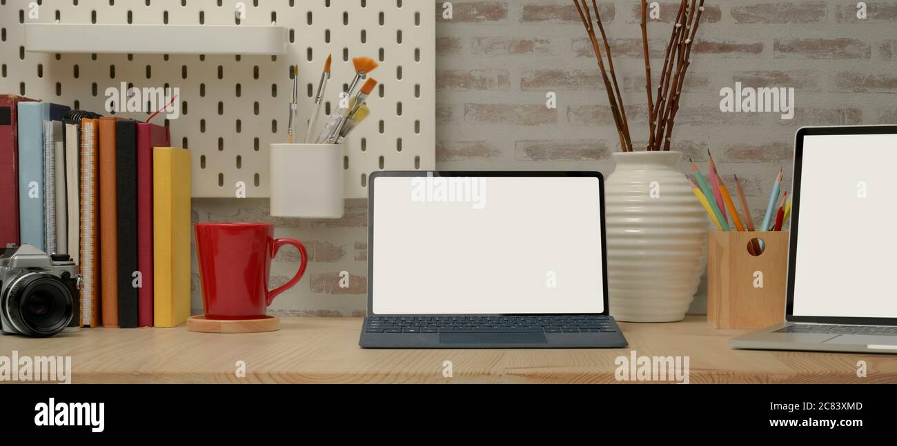 Close up view of study tale with mock up tablet, laptop, books, camera ...