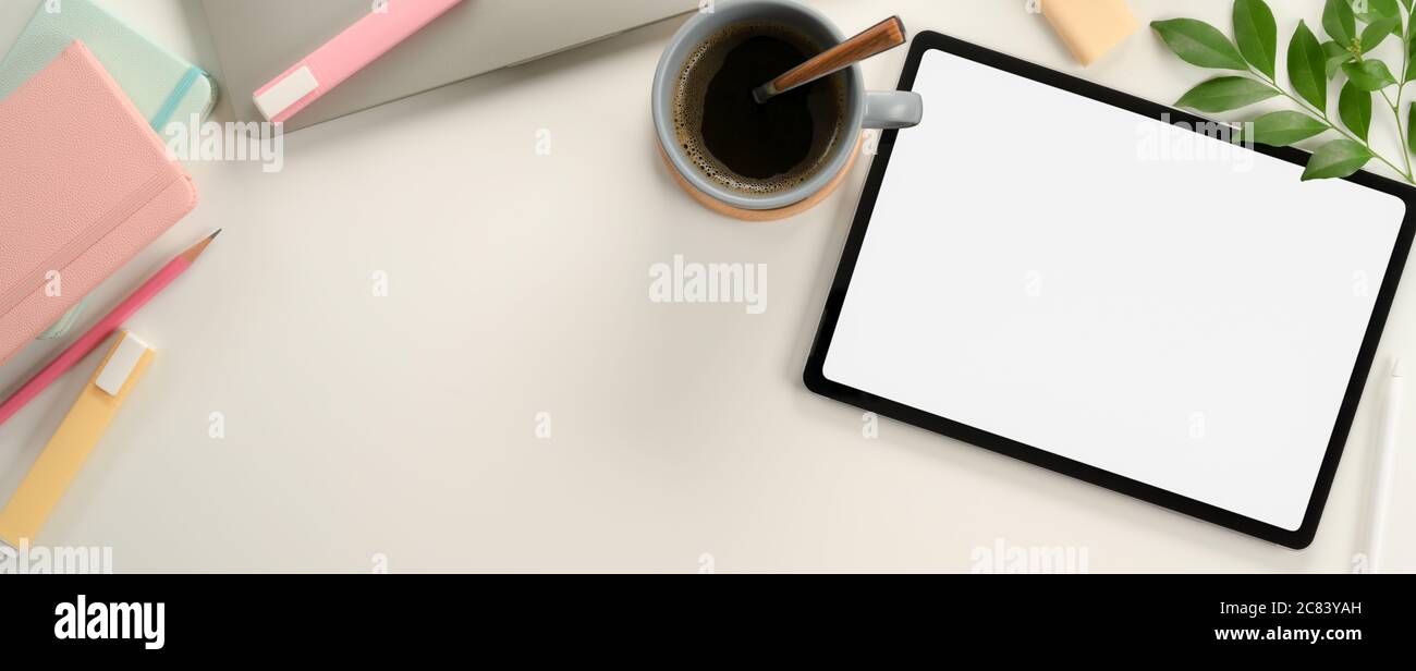 Top view of feminine study table with mock up tablet, laptop ...