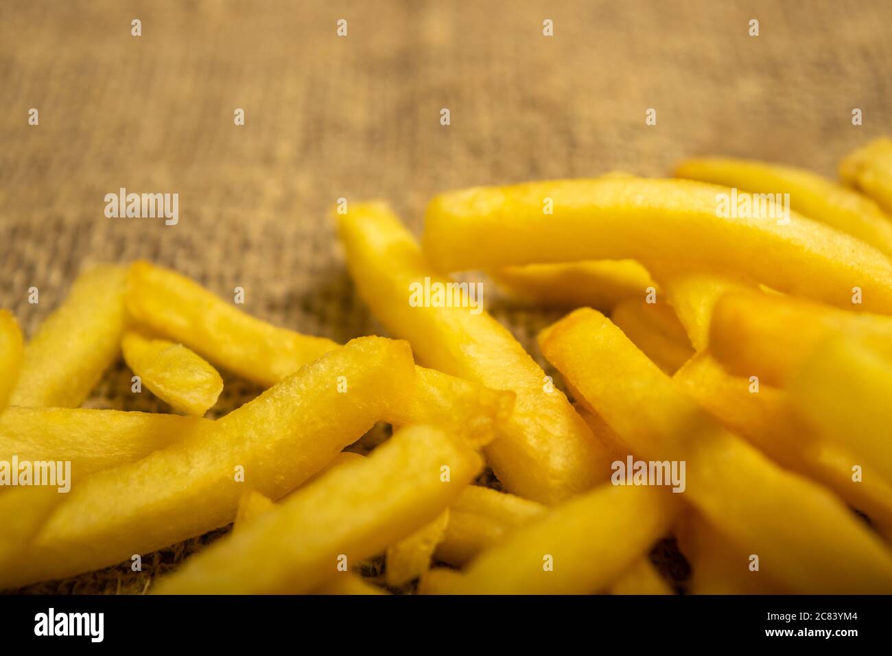 French fries on a homespun fabric with a rough texture. Close up Stock ...