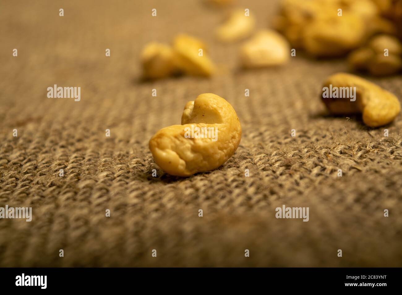 A pile of cashew nuts on burlap with a rough texture surface texture ...