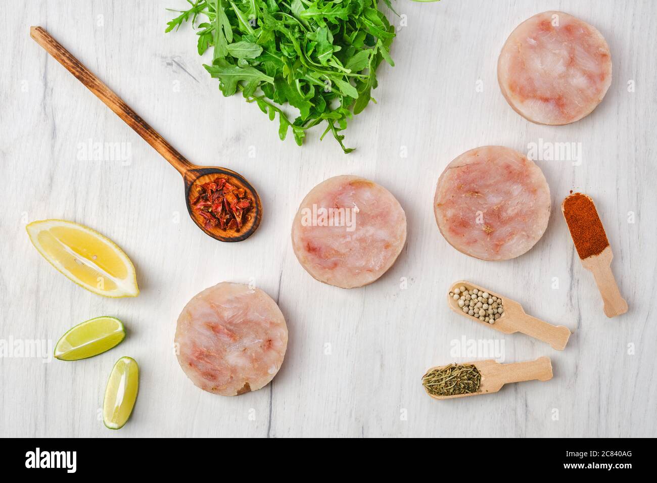 Frozen round fish cutlet with spice Stock Photo - Alamy