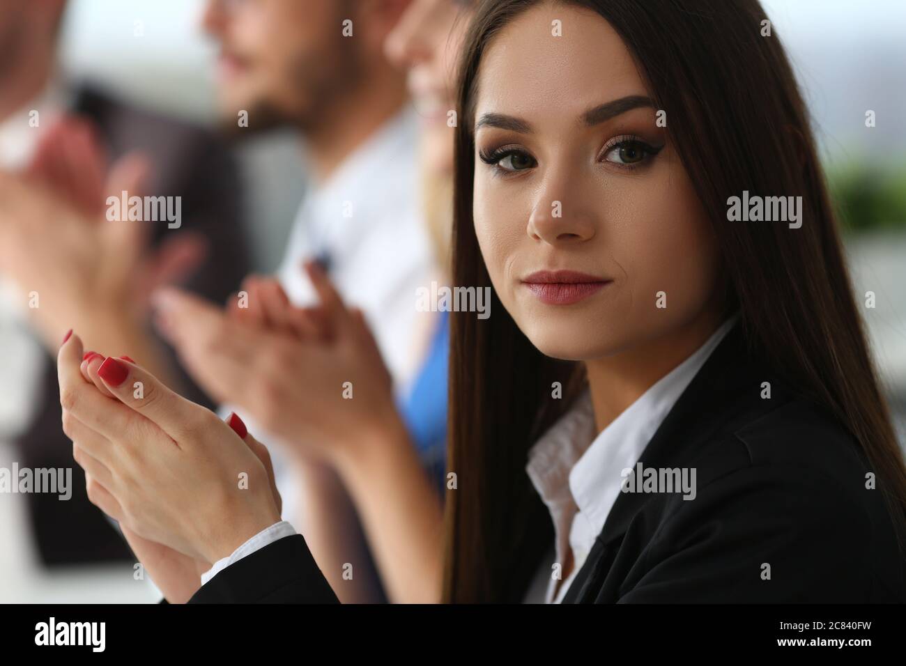 Group of managers clapping their hands in row Stock Photo - Alamy