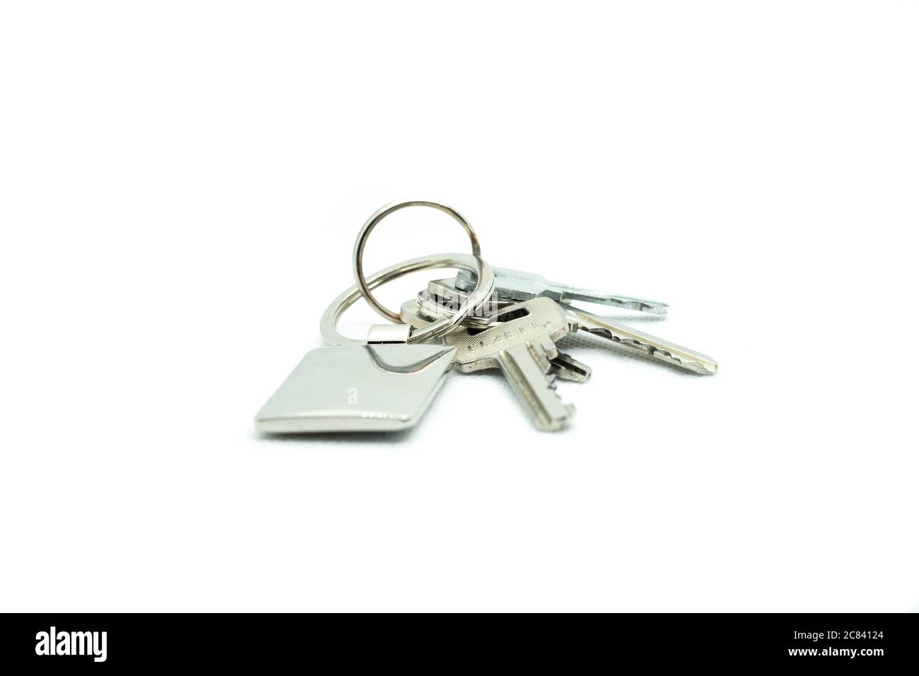 Silver keys isolated on a white background Stock Photo - Alamy