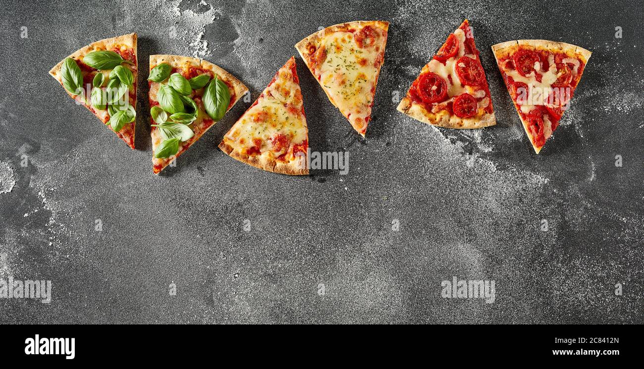 Sliced portions of Italian pizza with assorted trimmings arranged in a ...