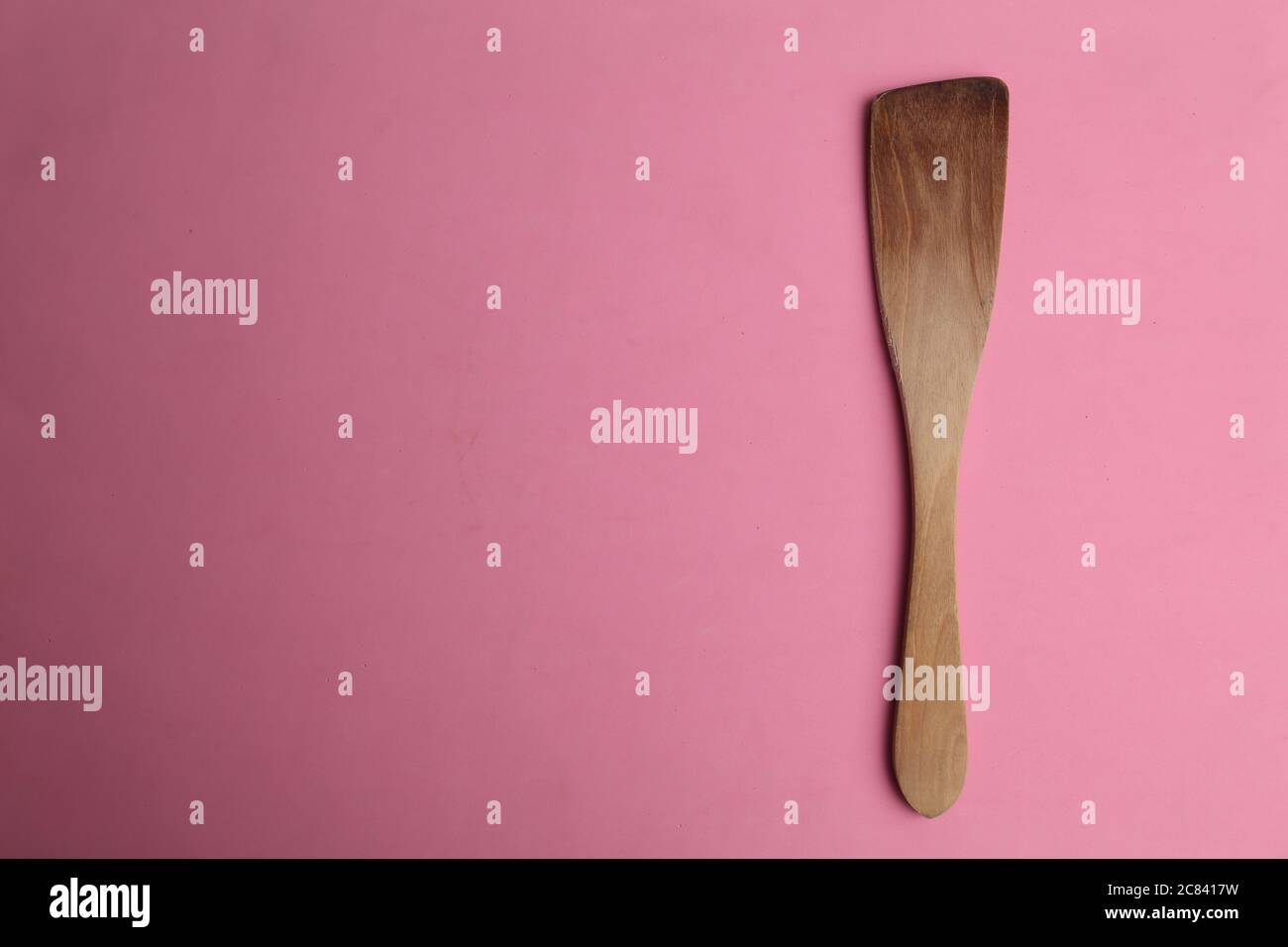 Top view of wooden spatula on pink background Stock Photo - Alamy