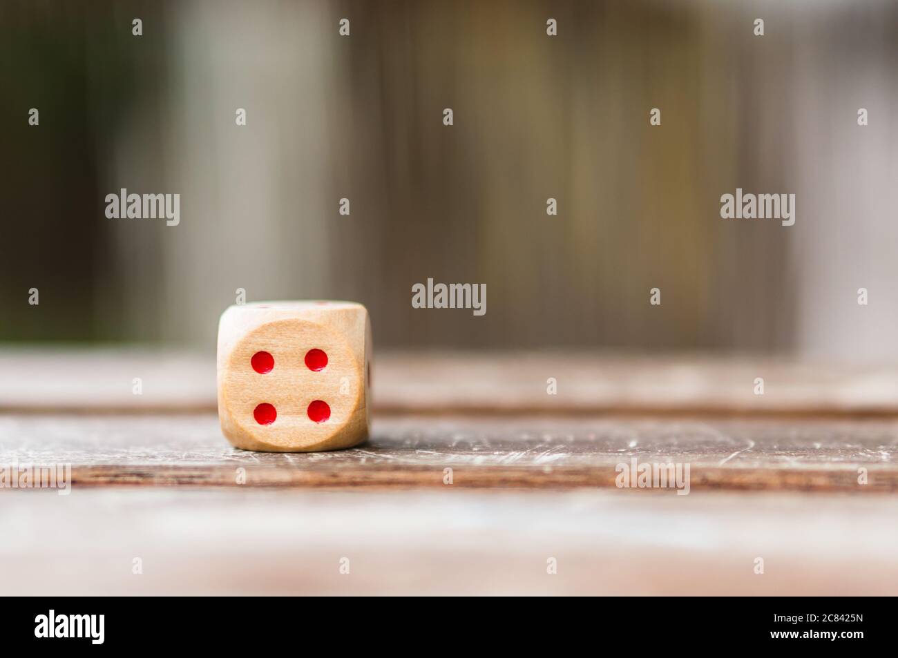 Selective focus shot of a wooden die with four red spots Stock Photo ...